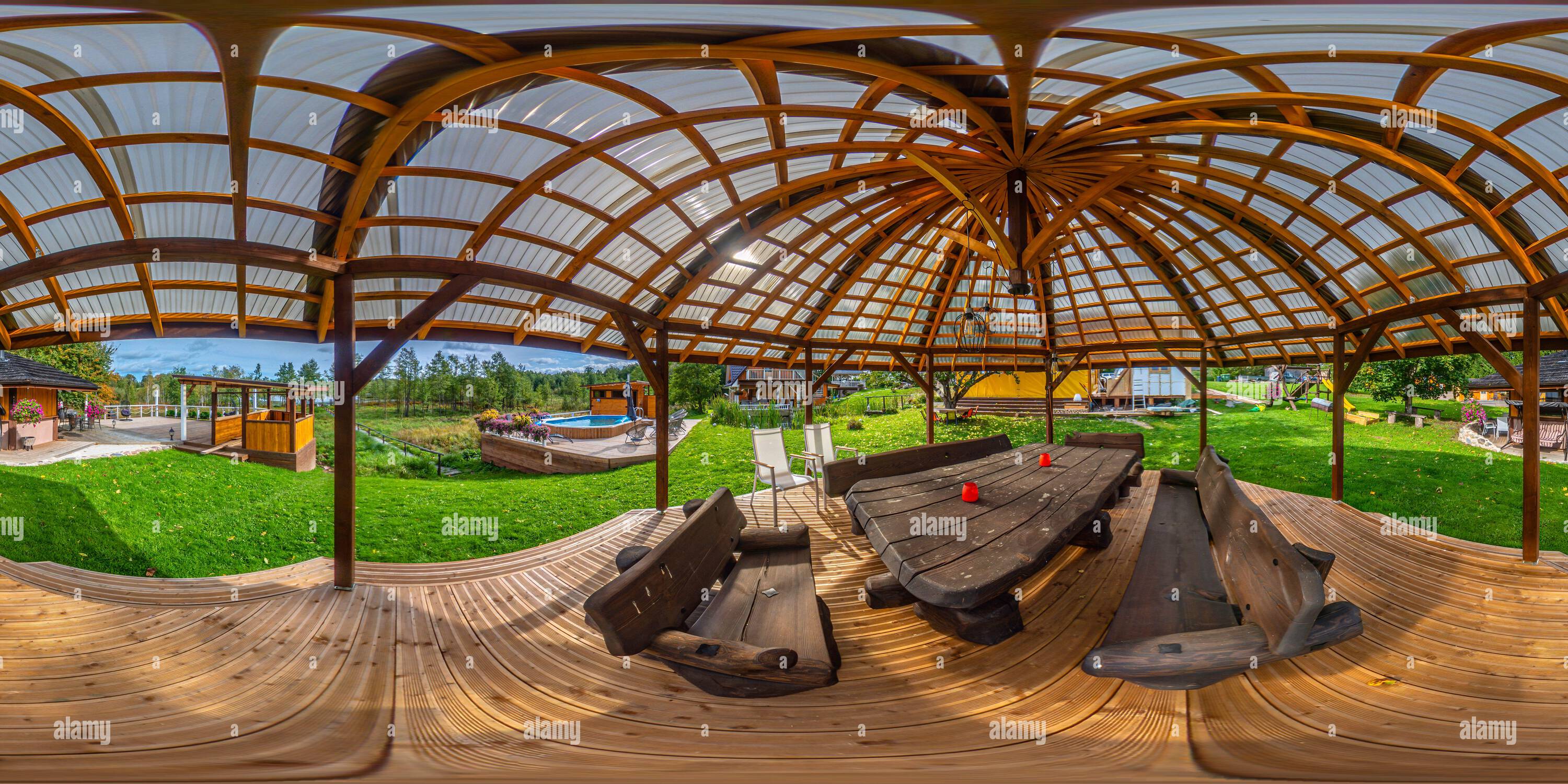 360° view of Sunny wooden terrace with sunshade, chairs and a table - Alamy