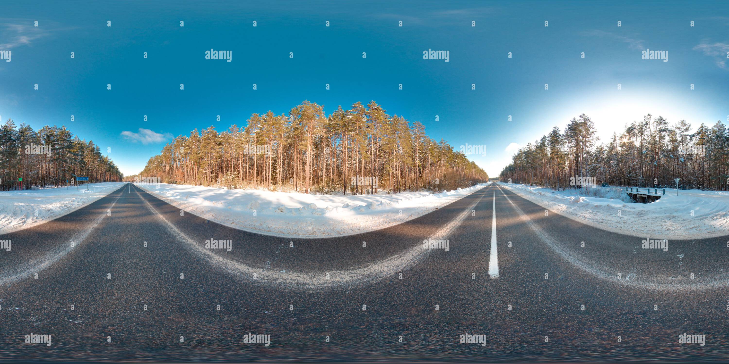 360° view of Beautiful landscape with trees blue road sky sun snow at ...