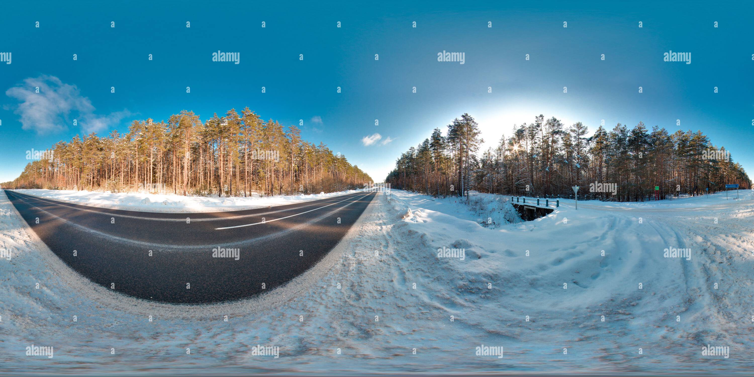 360° view of Beautiful landscape with trees blue road sky sun snow at ...