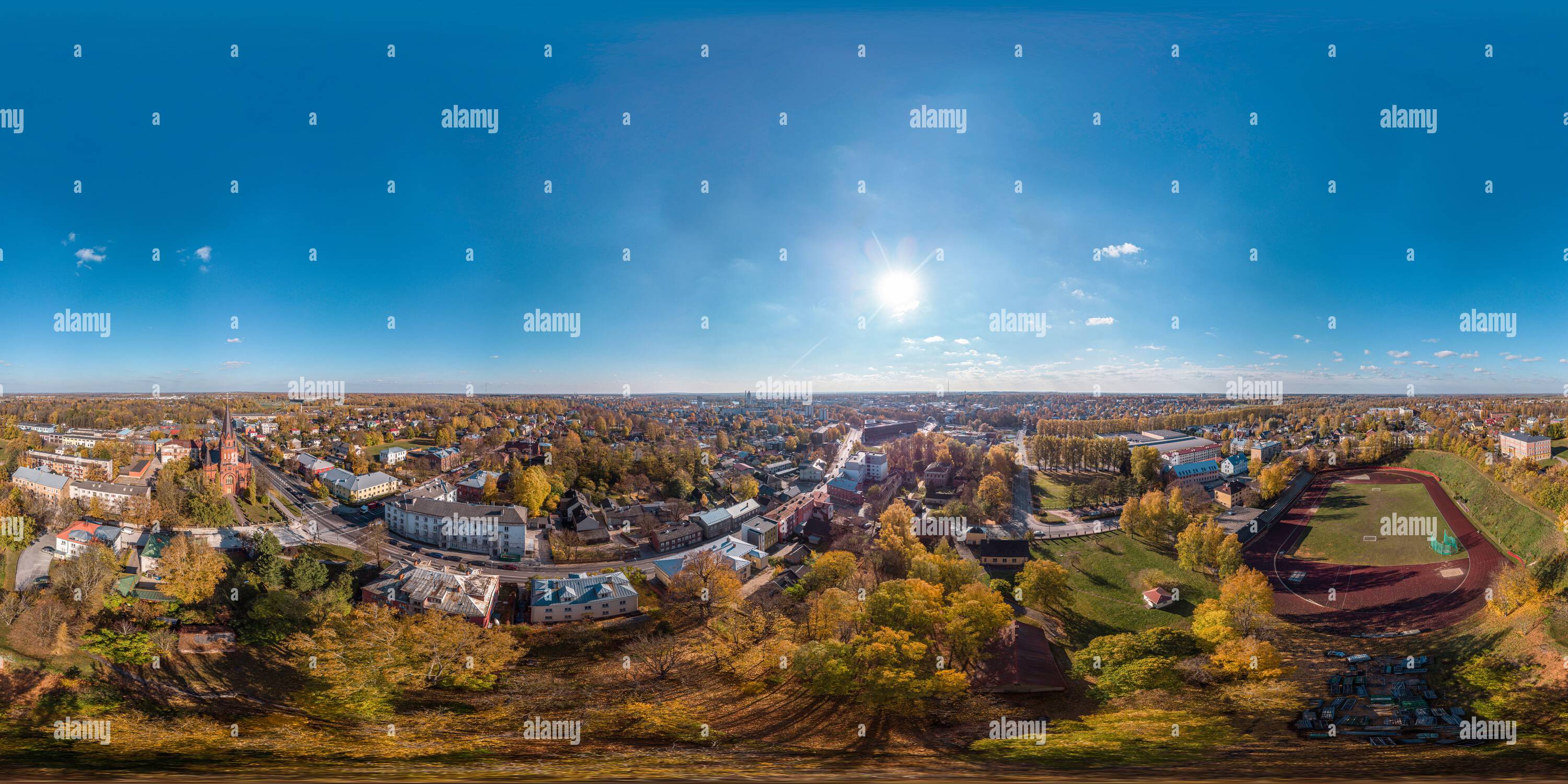 360° view of Drone view of a small town with a church and a stadium in ...