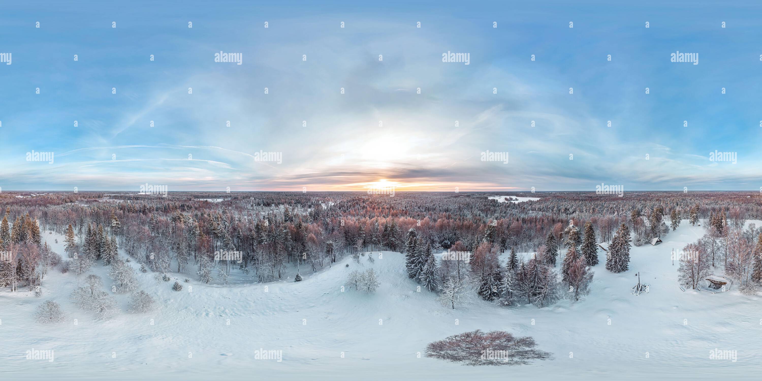 360° view of 360 aerial view of winter sunset over a snowy forest and ...