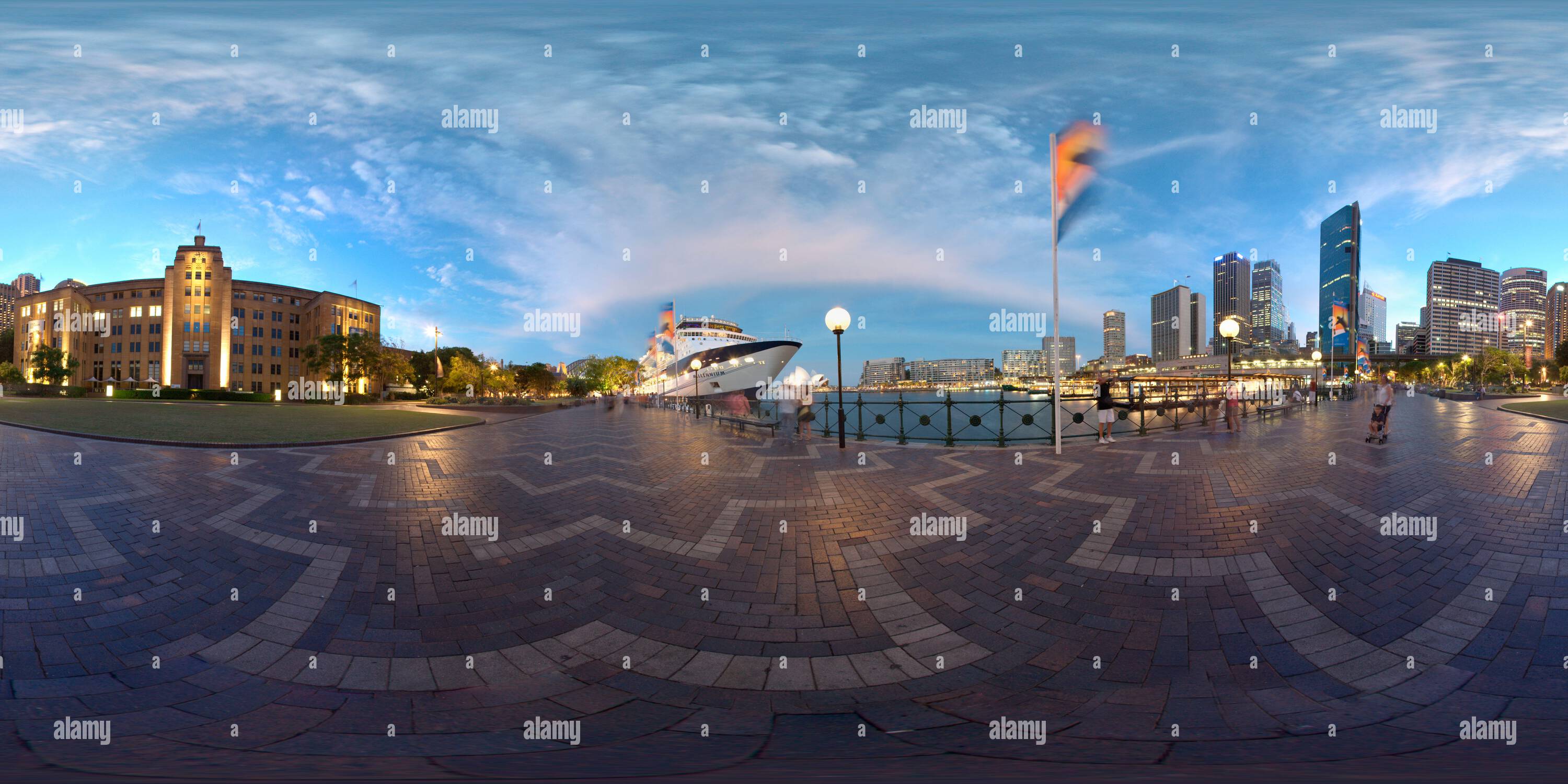 360° view of Panoramic view of a waterfront cityscape at dusk ...