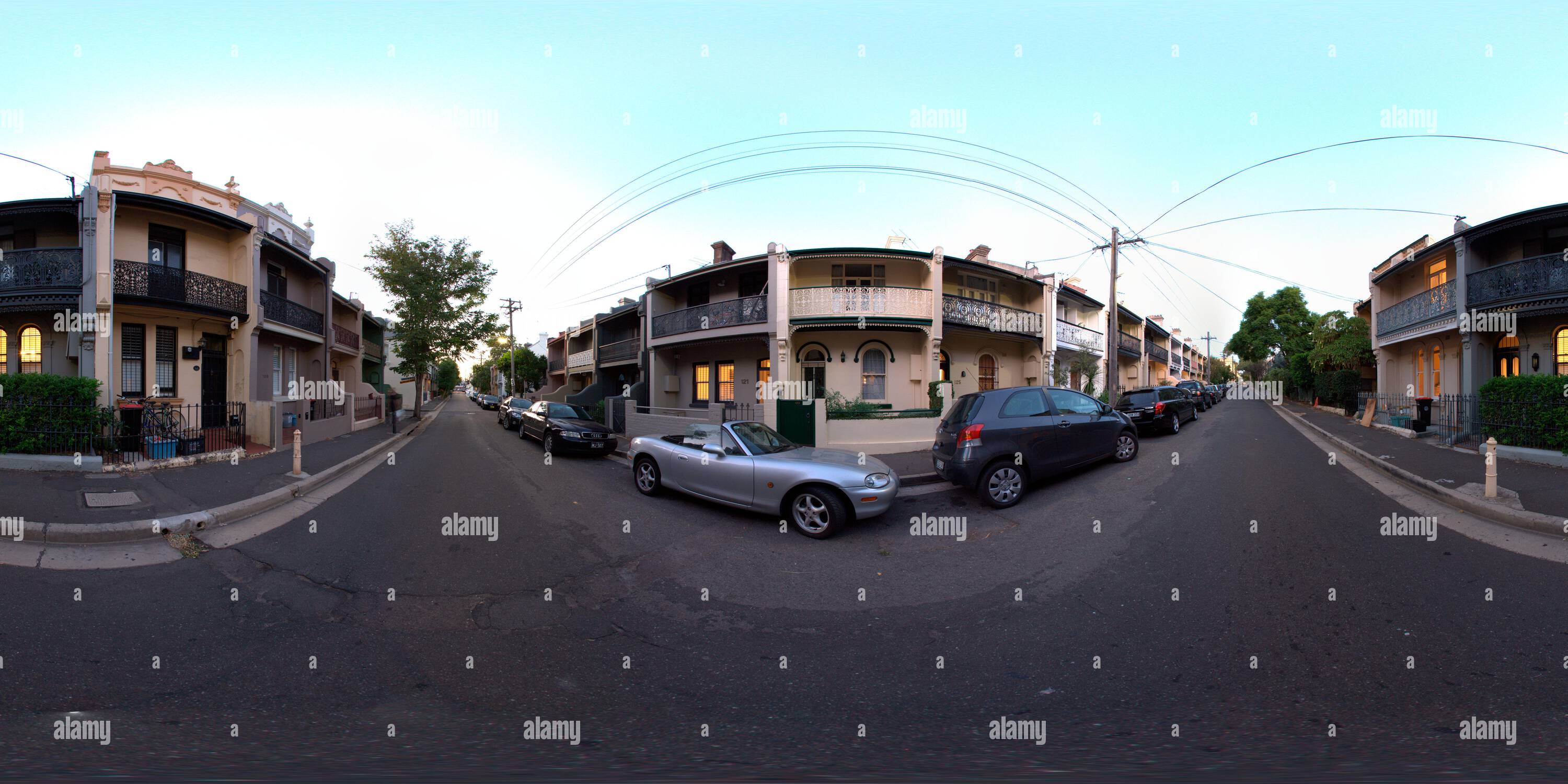 360° view of Panoramic view of a quiet residential street with parked ...