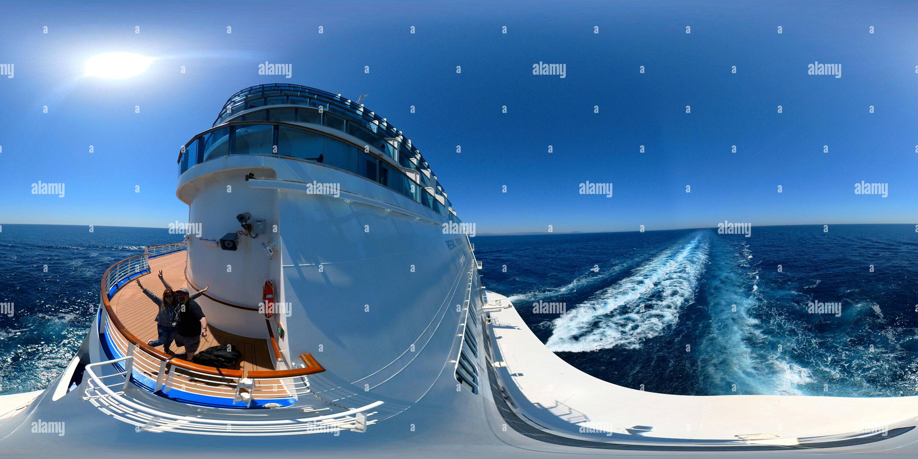 360° view of Couple standing at the back of the Regal Princess Cruise ...