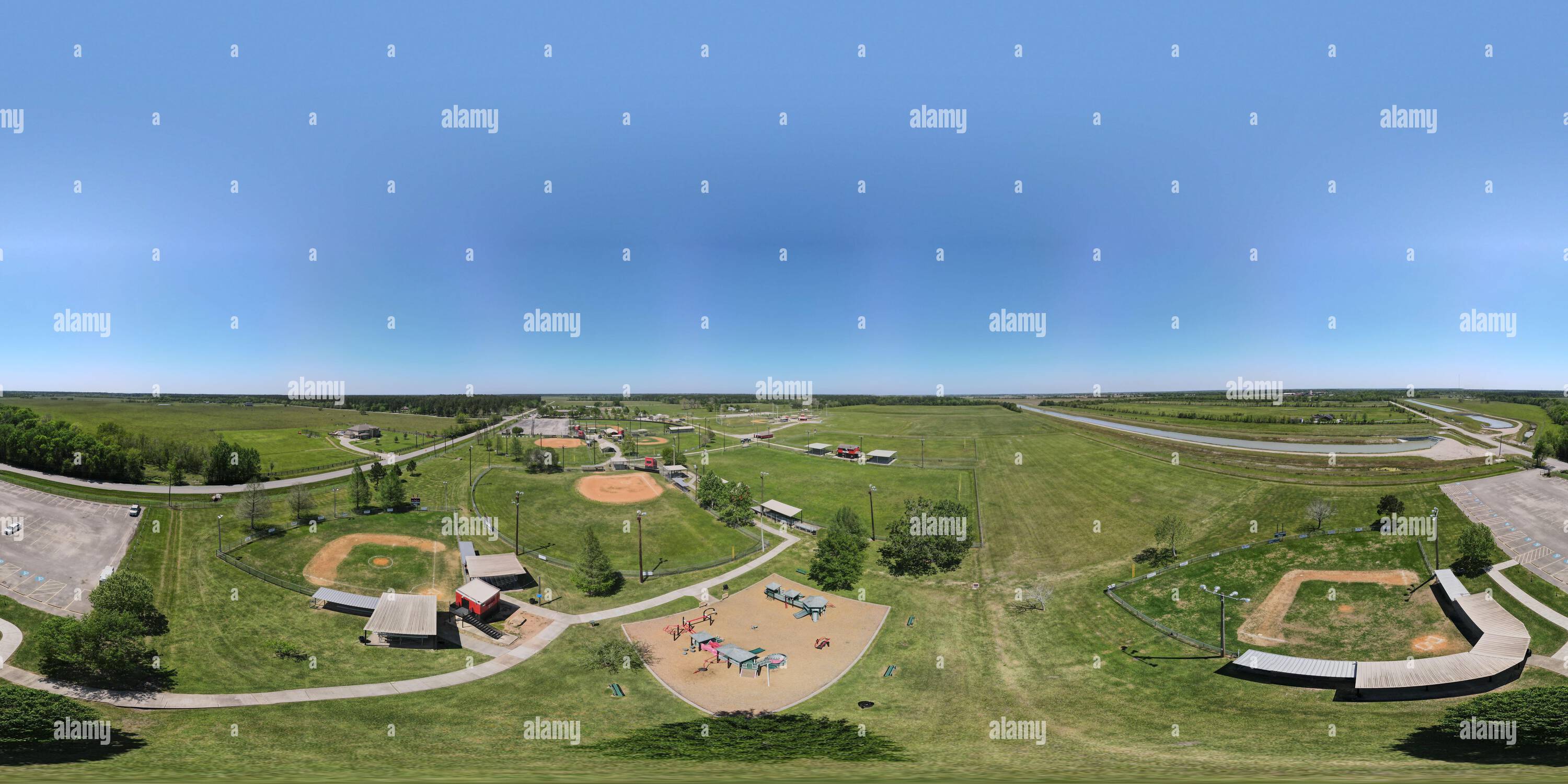 360° view of Empty and worn down baseball fields on a clear summer day ...