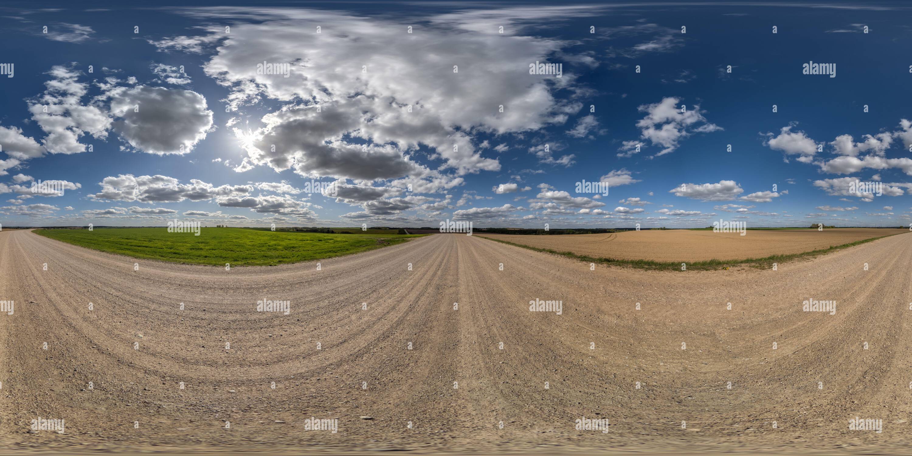 360° view of 360 hdri panorama on white sand gravel road with clouds on ...
