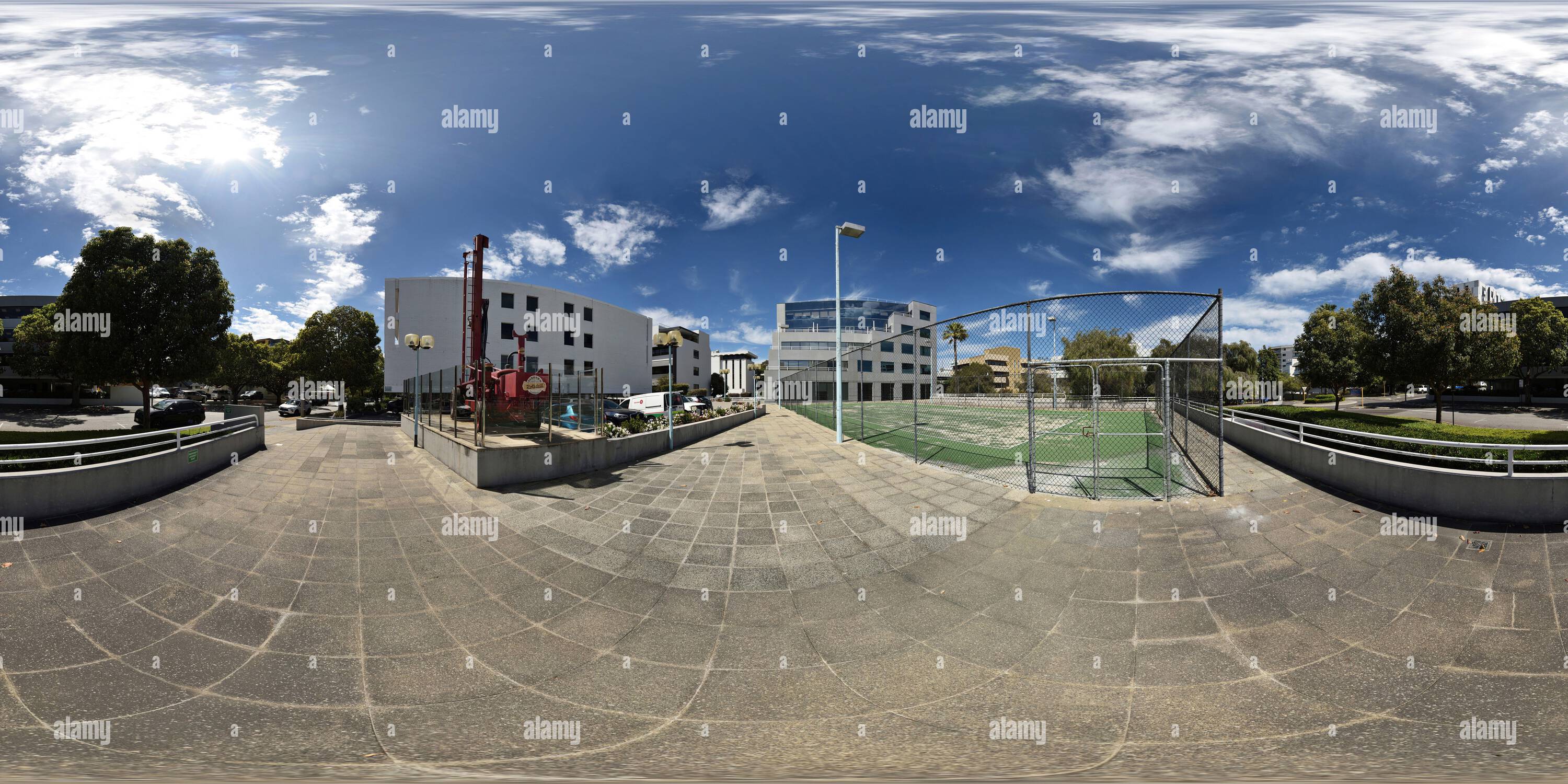 360° view of A Tennis Court and small plaza behind a commercial office ...