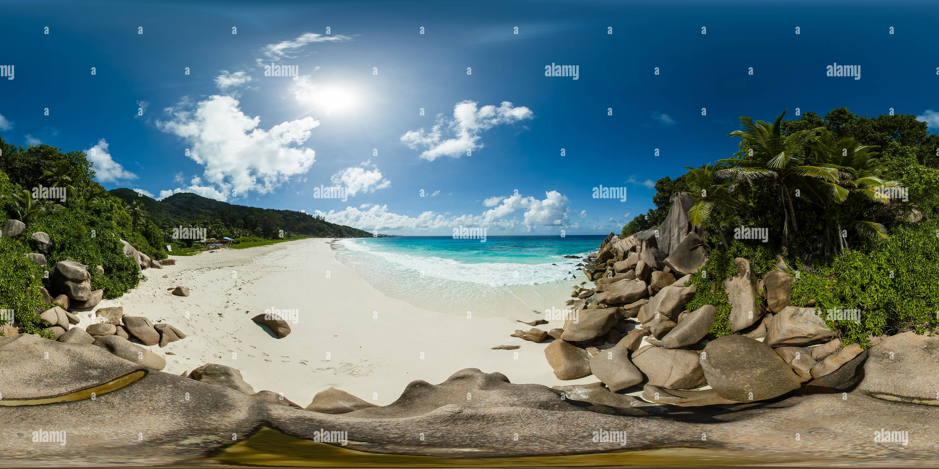 360° view of Sunlit beach with boulders and soft waves. La Digue ...