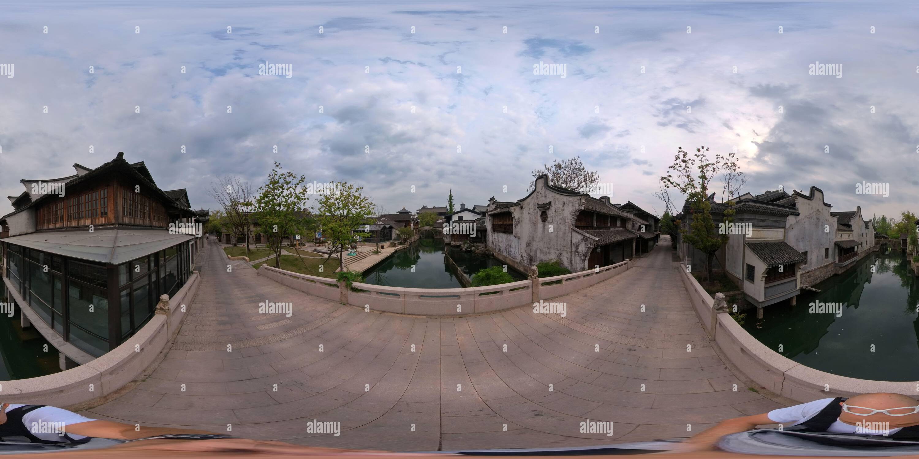 360° view of 360 view of A majestic wooden temple with a traditional curved roof sits atop wide ...