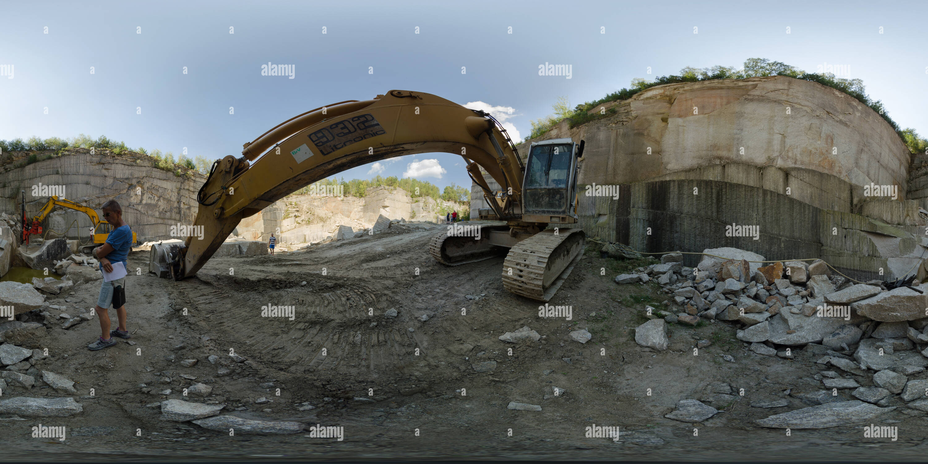 360° view of Excavator in the granite quarry - Alamy