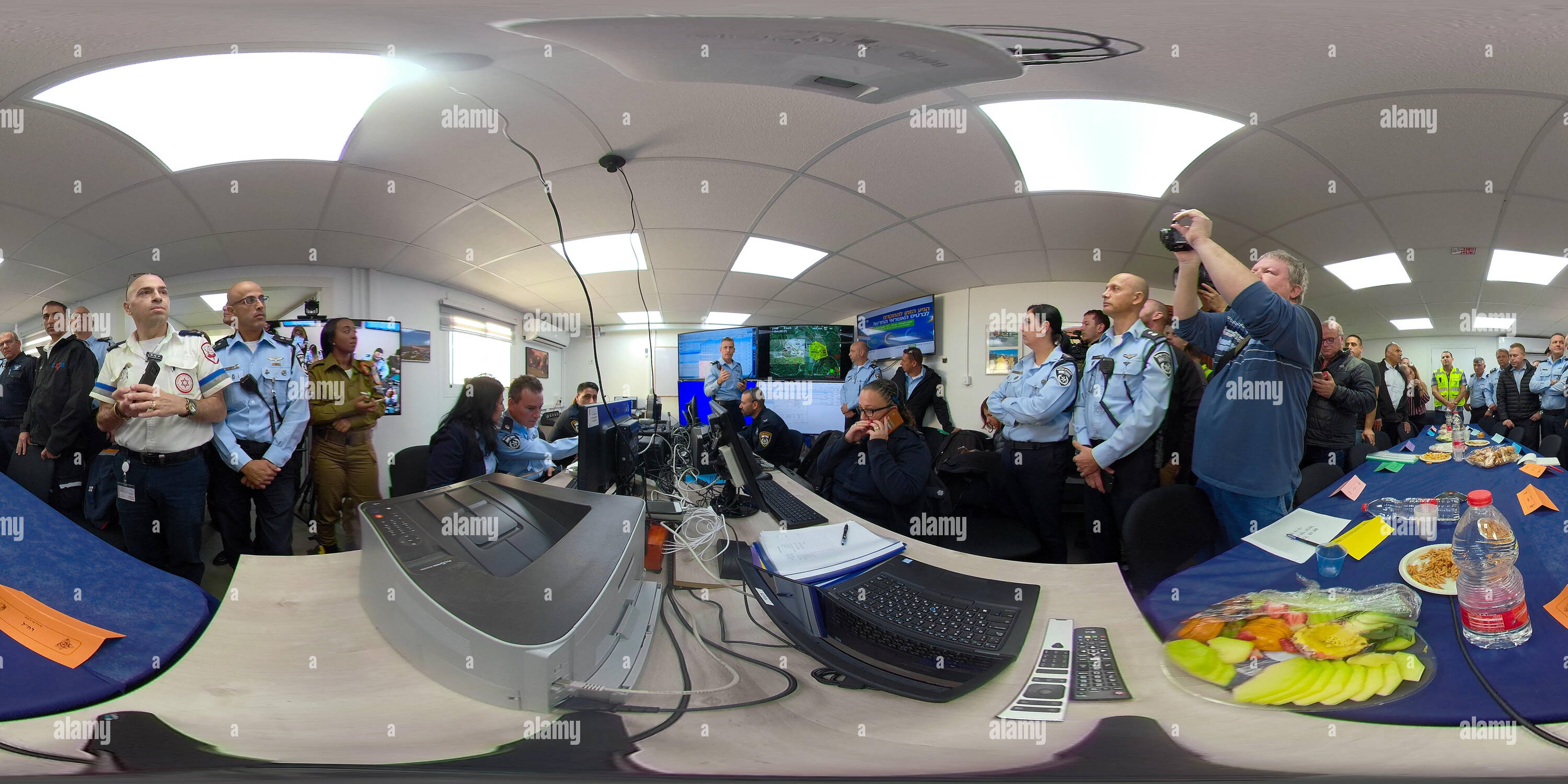 360° view of Police officer briefing police and firefighters regarding ...